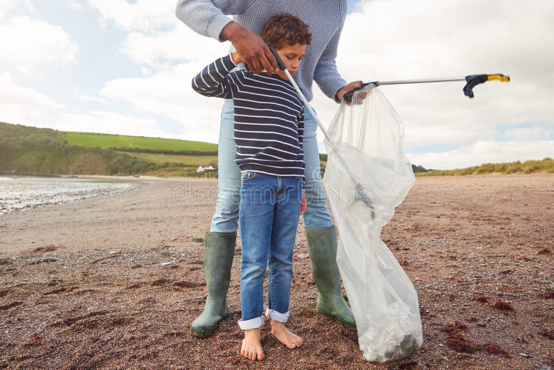 Father and Son Collecting Litter on Winter Beach Clean Up Stock Image ...