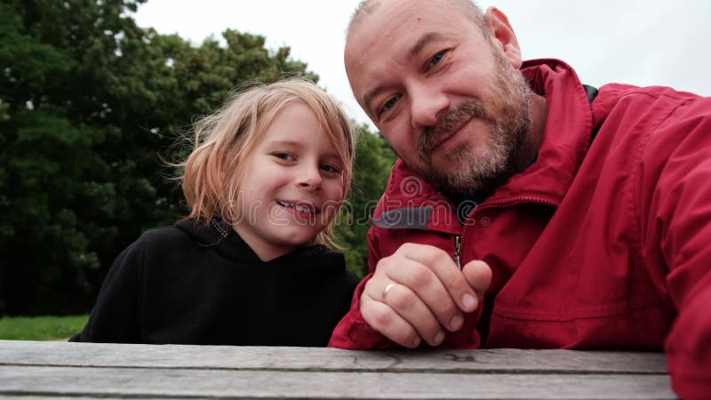 Father and Son Communicate by Video Communication Together. they Smile ...