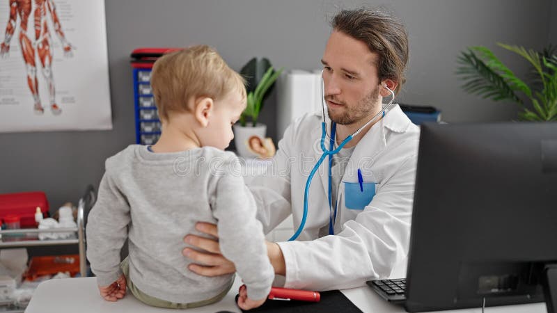 Father and Son Doctor Examining Child at Clinic Stock Photo - Image of ...