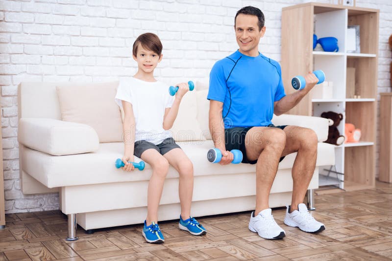 Father and Son Doing Exercises with Dumbbells. Stock Photo - Image of ...