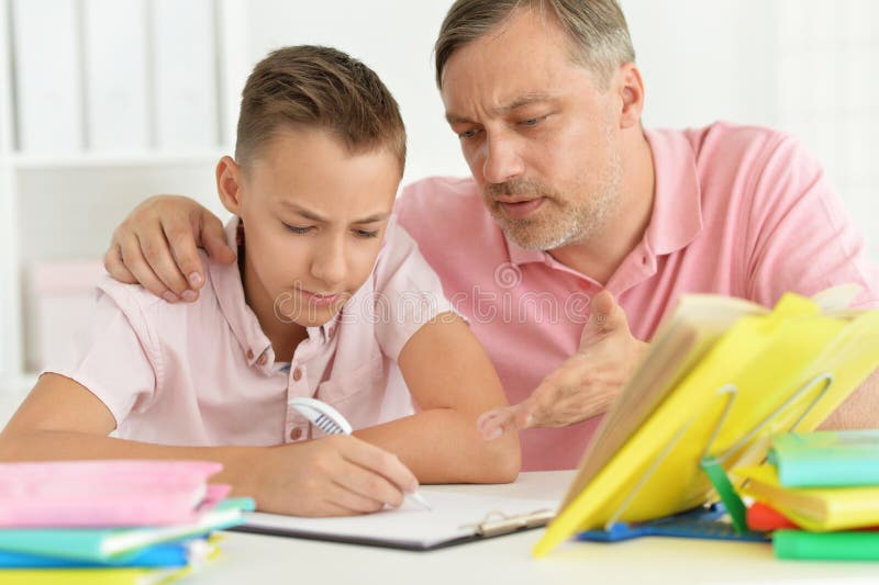 Portrait of Father and Son Doing Homework Stock Photo - Image of ...