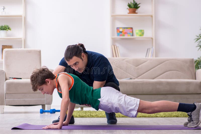Father and Son Doing Sport Exercises Indoors Stock Photo - Image of ...