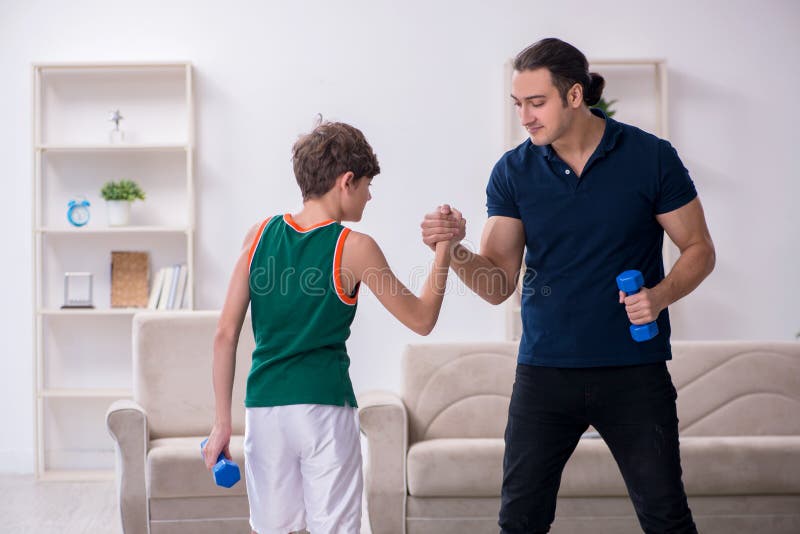 Father and Son Doing Sport Exercises Indoors Stock Image - Image of ...