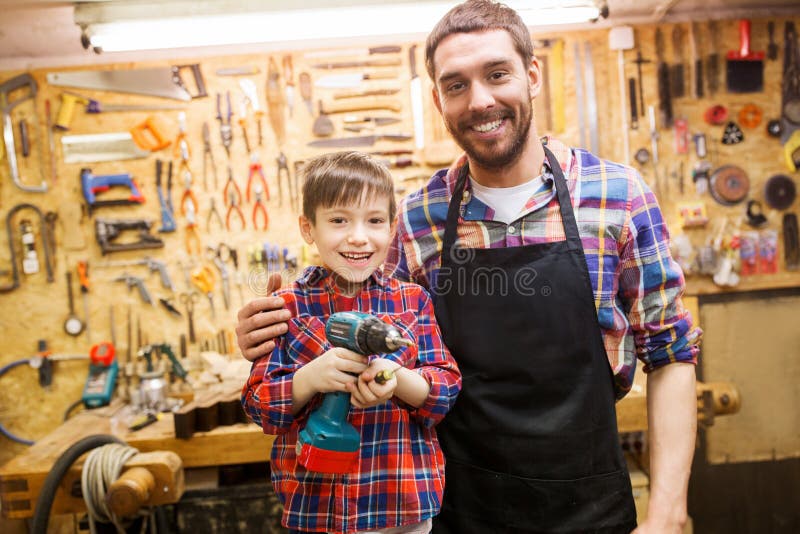 Father and Son with Drill Working at Workshop Stock Image - Image of ...