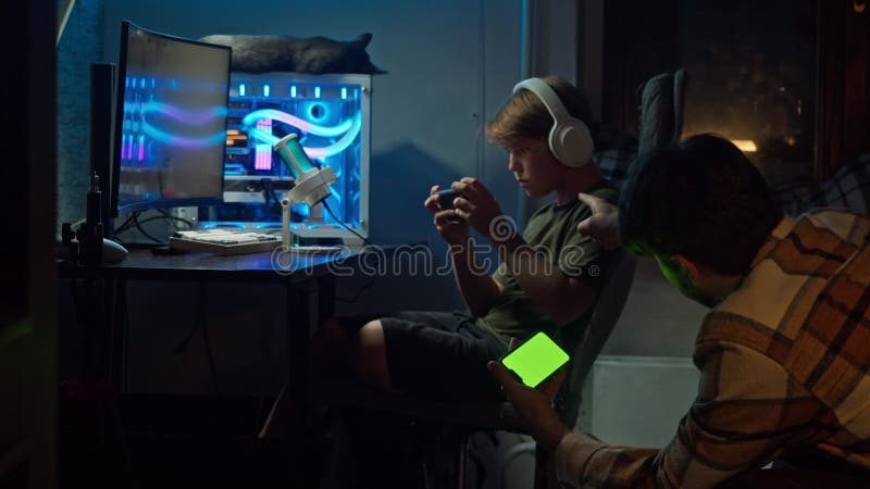 A Father and Son Engage in Playing Computer Games Together Using ...