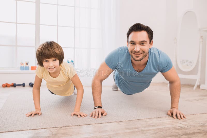 Father and Son Exercise Together at Home Stock Image - Image of ...