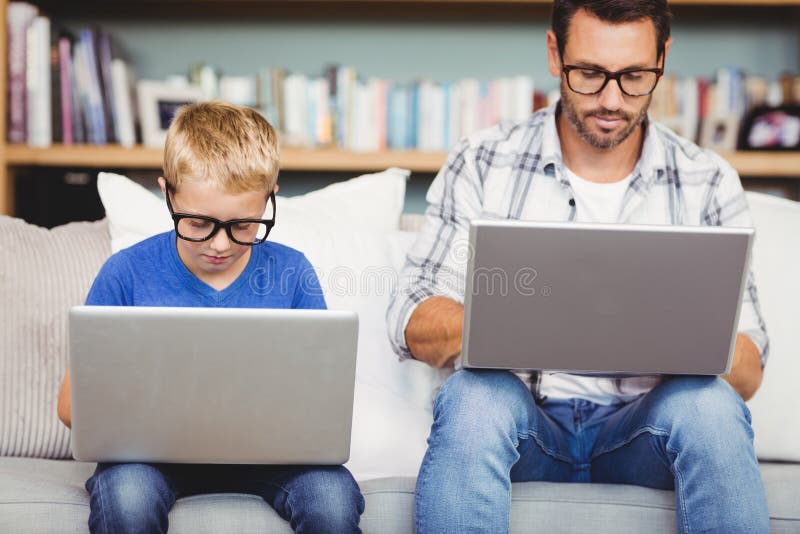 Father and Son with Eyeglasses Working on Laptop Stock Image - Image of ...