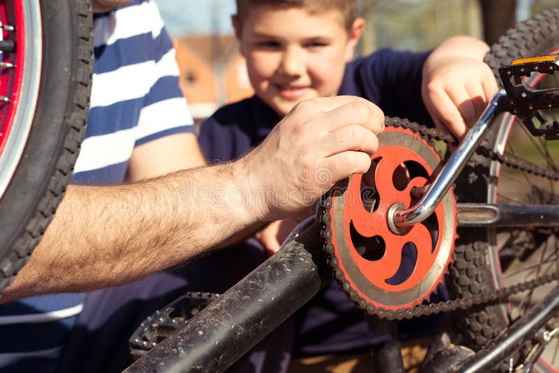 Father and son fixing bike stock photo. Image of happy - 69343456