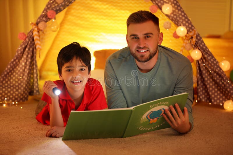 Father and Son with Flashlight Reading Book Stock Image - Image of ...