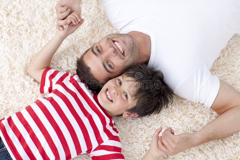 Father and Son on Floor with Heads Together Stock Image - Image of ...