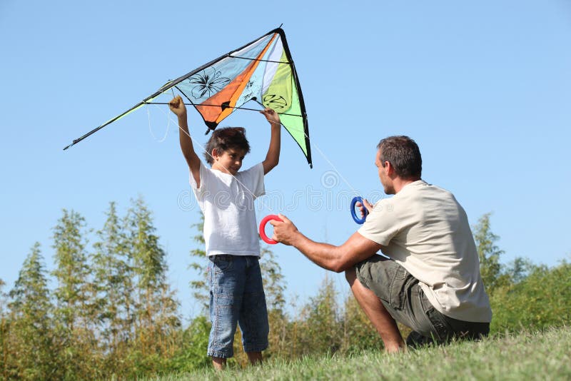 Father and son flying kite stock image. Image of ribbons - 35900765