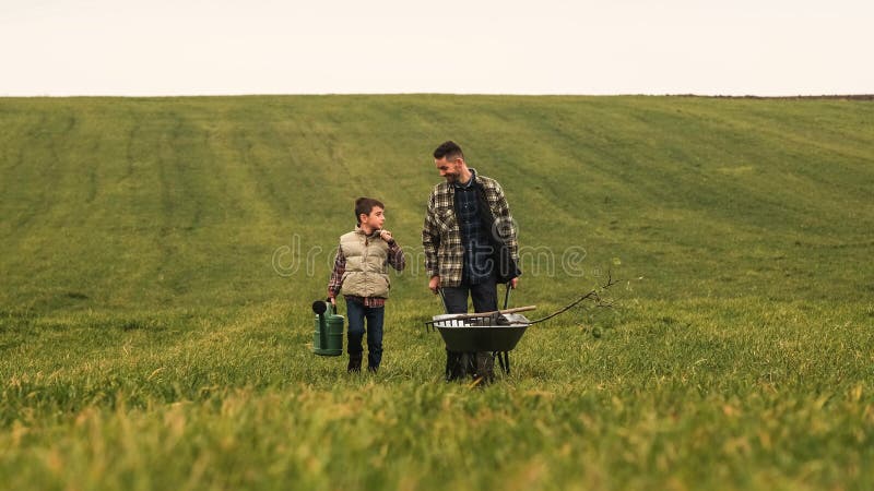 The Father and Son are Going To Work at the Field. Stock Photo - Image ...