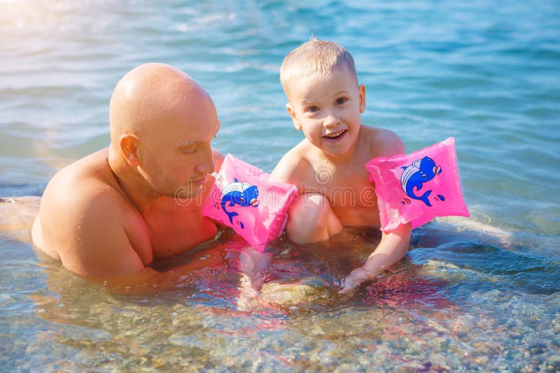 Father and Son Happy Swimming in the Sea Stock Photo - Image of blue ...