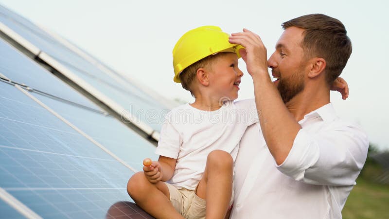 Father and Son with Hard Hats Near Solar Panel, Engineering Concept ...