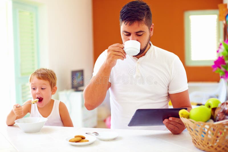 Father and Son Having Breakfast in the Morning at Home Kitchen Stock ...