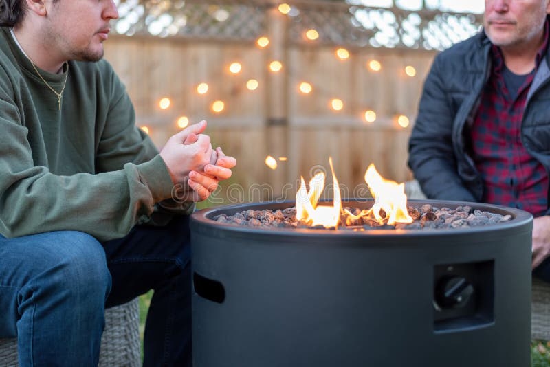 Father and Son Having a Fireside Chat in the Backyard Stock Photo ...