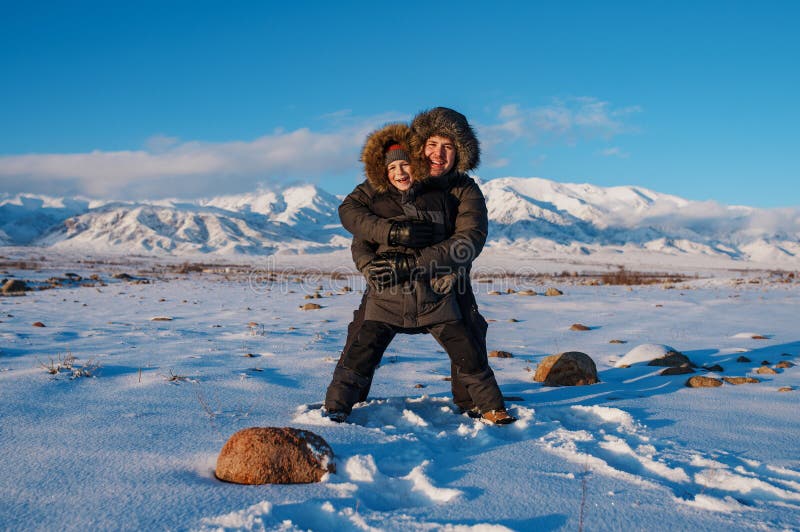 Father and Son Having Fun in Hooded Winter Jackets Stock Photo - Image ...