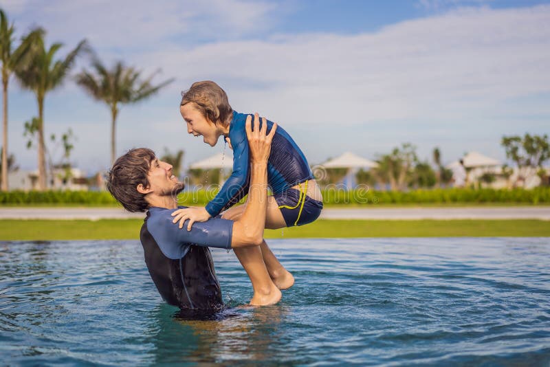Father And Son Having Fun In The Swimming Pool Stock Photo - Image of ...