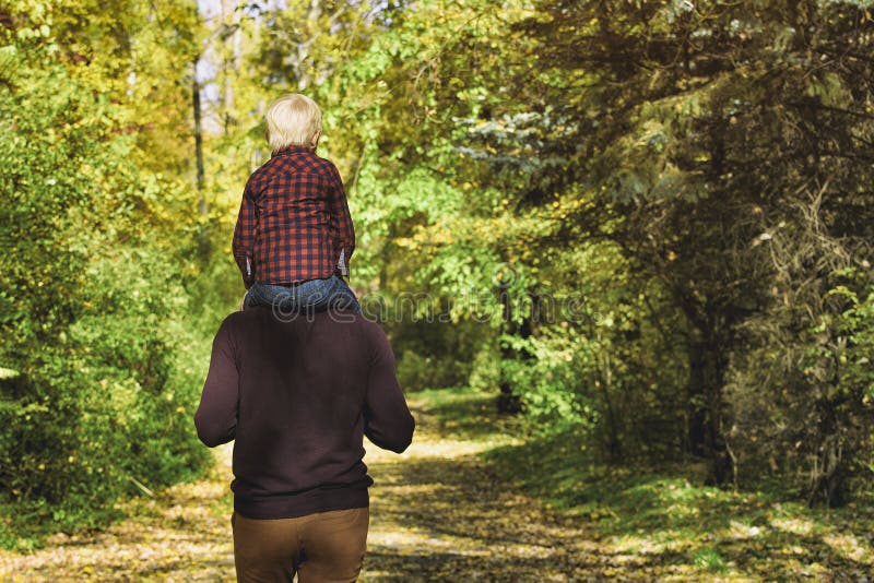 Father With Son On His Shoulders Walking In The Autumn Forest B Stock