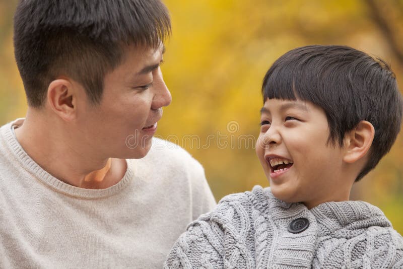 Father and Son Laughing in the Park in Autumn, Close-up Stock Photo ...