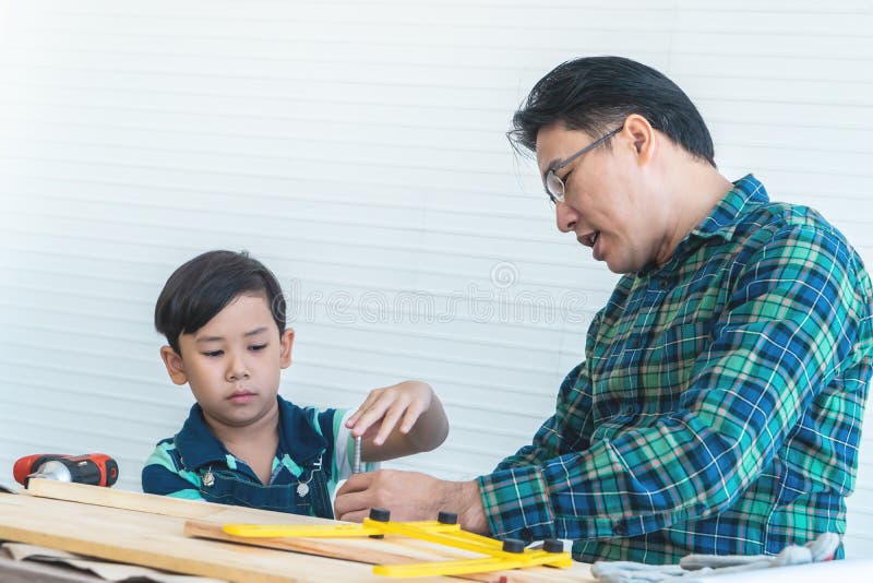 Father and Son Learning To Work on Wood Work with Tools for Family ...