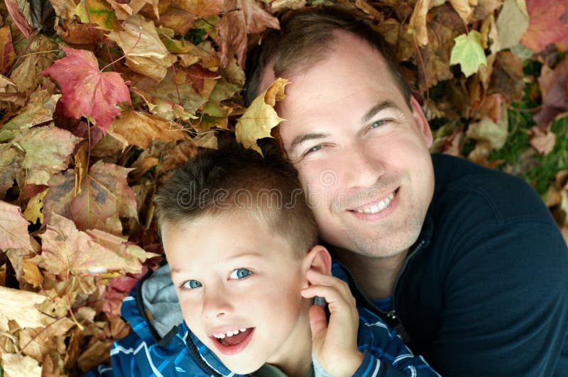 Father and Son in the Leaves Stock Image - Image of leaves, father ...
