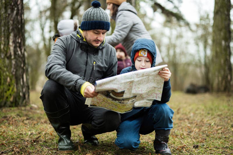 Father with Son Looking at Map in the Forest Stock Image - Image of ...