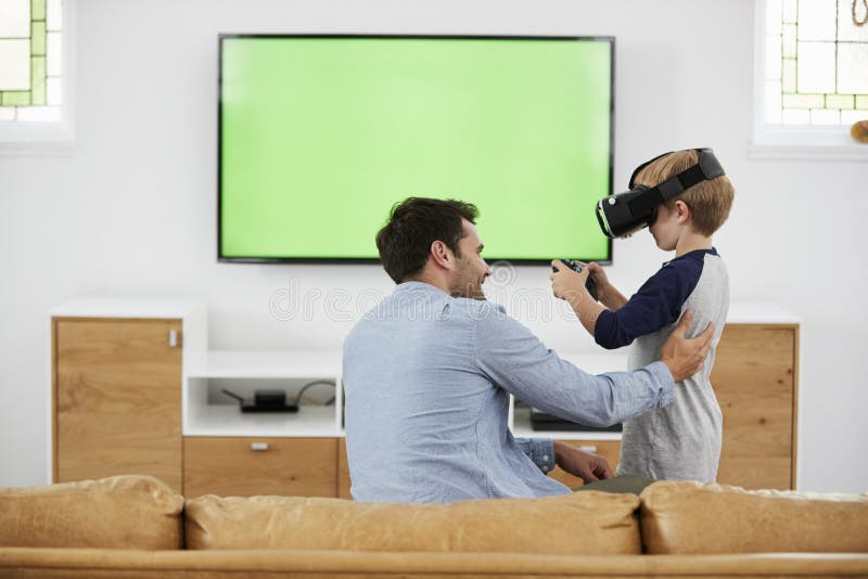 Father and Son Play Computer Game Using Virtual Reality Headset Stock ...