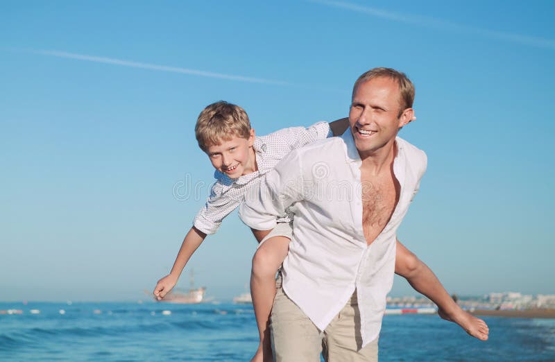 Son and Father Play in Football Stock Image - Image of leisure, green ...