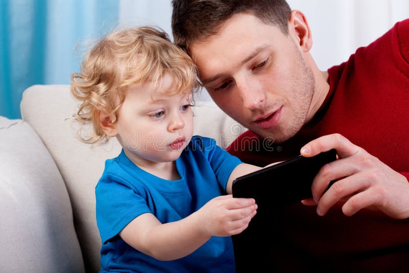 Father and Son with a Cell Phone Stock Photo - Image of family ...