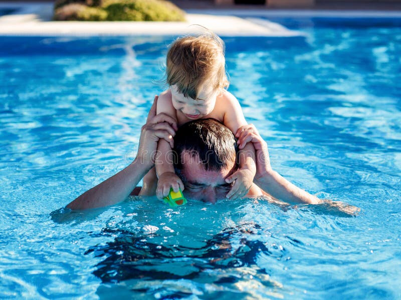 Father and Son Playing in the Pool Stock Image - Image of love, adult ...