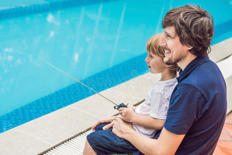 Father and Son Playing with a Remote Controlled Boat in the Pool Stock ...