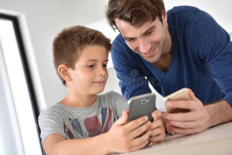 Father and Son Playing on Smartphone Stock Image - Image of adult ...
