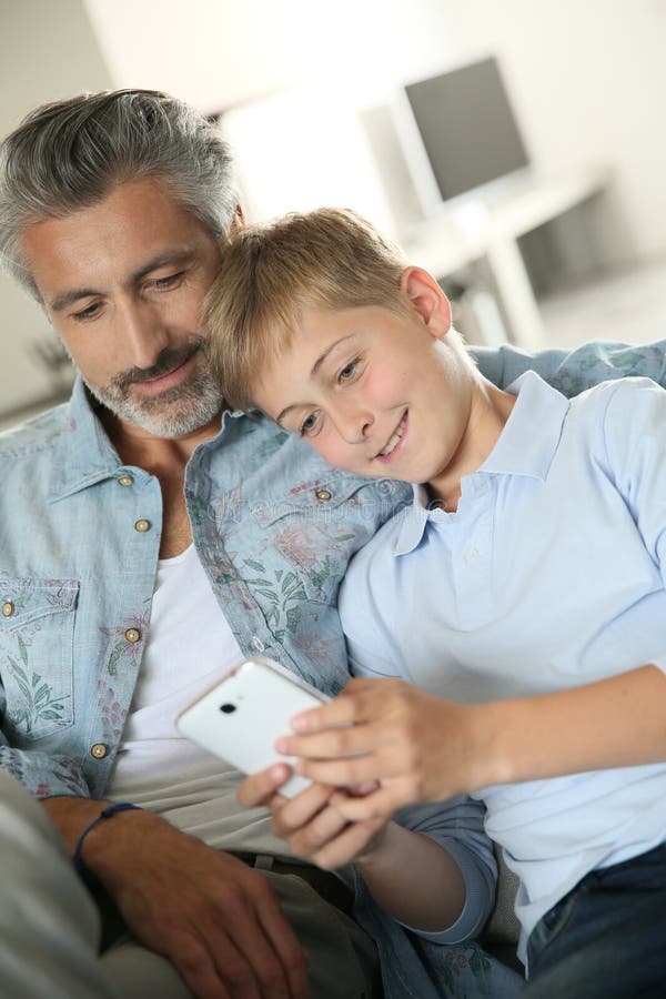 Father and Son Playing on Smartphone Stock Photo - Image of caucasian ...