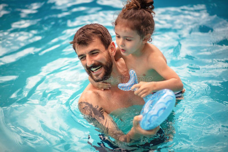Father and Son Playing Together in the Swimming Pool Stock Photo ...