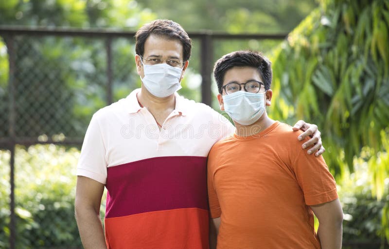 Father and Son with Protective Face Mask Looking at Camera Stock Image ...