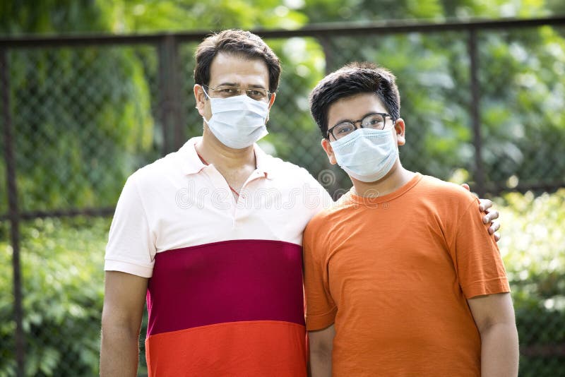 Father and Son with Protective Face Mask Looking at Camera Stock Image ...