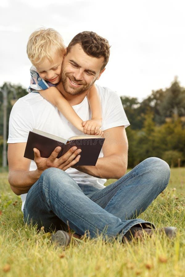 Father and Son Reading Book Stock Photo - Image of hugging, child: 63155488