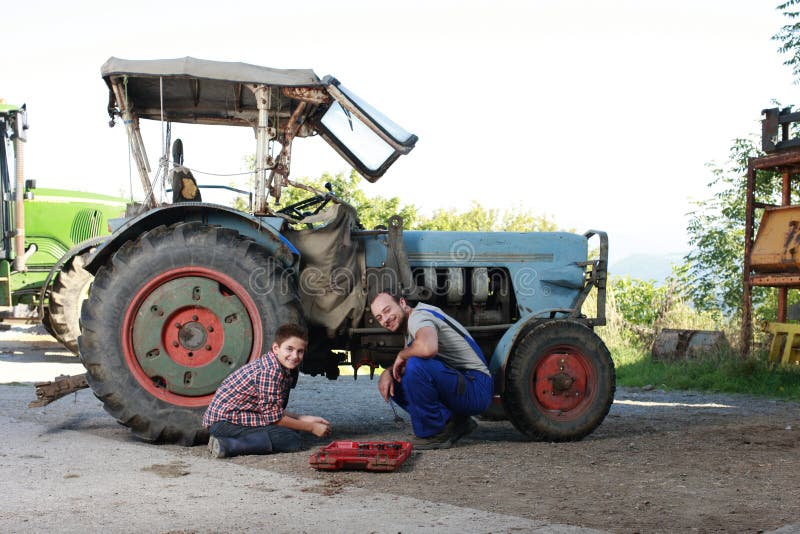 Father and Son Repairing a Tractor Stock Photo - Image of nature, tools ...