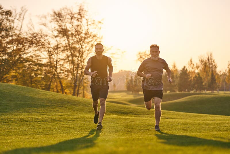 The Father and Son Running in the Beautiful Park. Stock Photo - Image ...