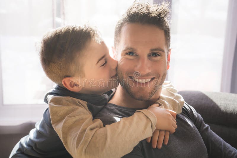 Father And Son Sit On The Sofa At Home Stock Image Image Of Caucasian