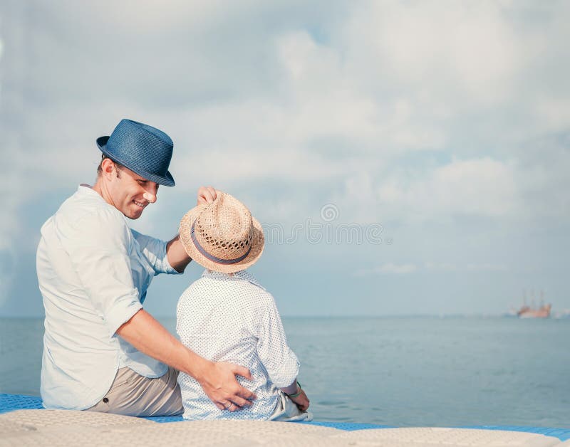Father with Son Sitting on the Sea Pier Stock Image - Image of male ...