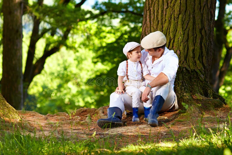 Father and Son Sitting Under an Old Tree Stock Image - Image of child ...
