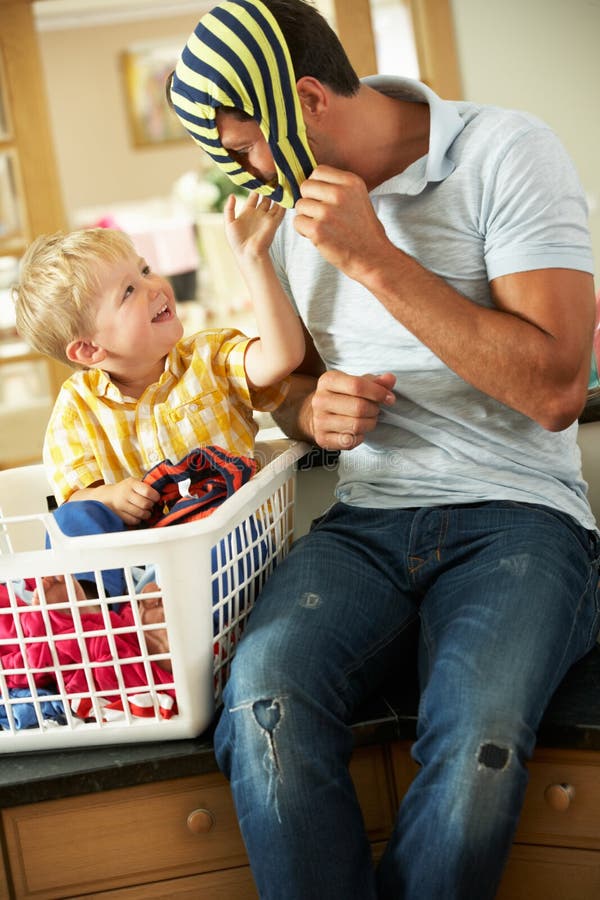 Father and Son Sorting Laundry Stock Image - Image of male, pants: 27704363