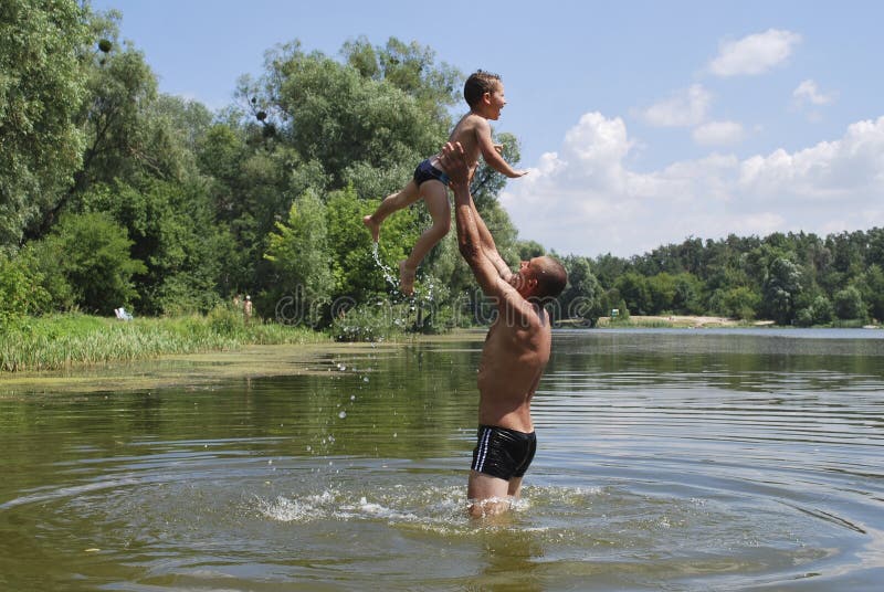 Father and Son Swimming in the River. Stock Photo - Image of childhood ...