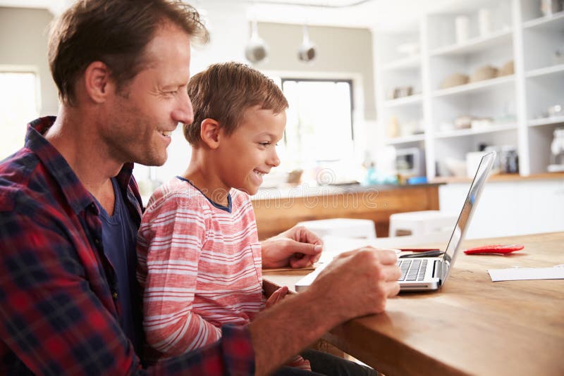 Father and Son Using Laptop Computer at Home Stock Photo - Image of ...