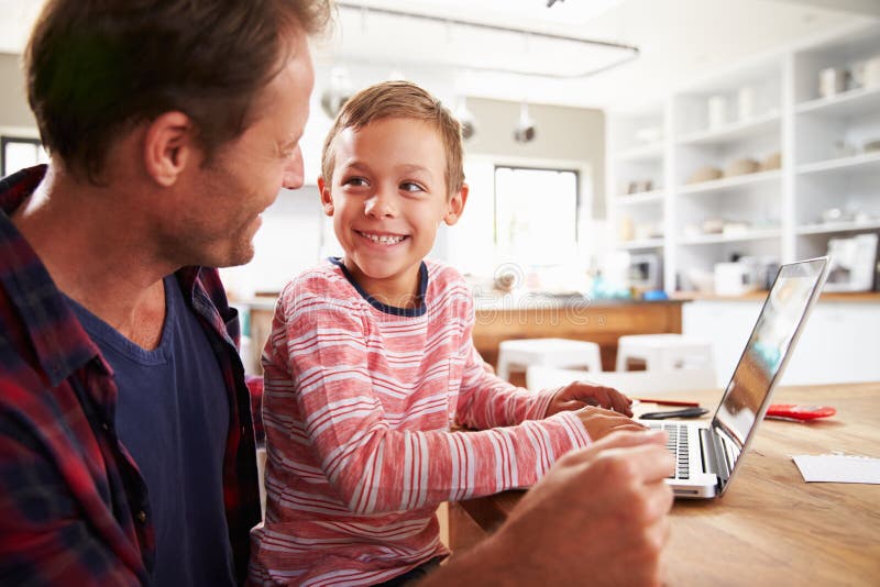 Father and Son Using Laptop Computer at Home Stock Photo - Image of ...