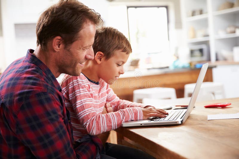 Father and Son Using Laptop Computer at Home Stock Image - Image of ...