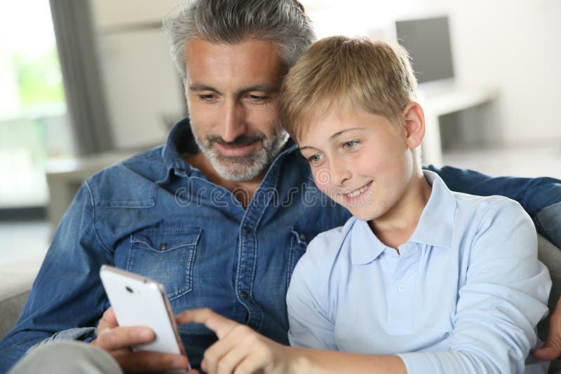 Father and Son Using Smartphone Stock Photo - Image of father, home ...