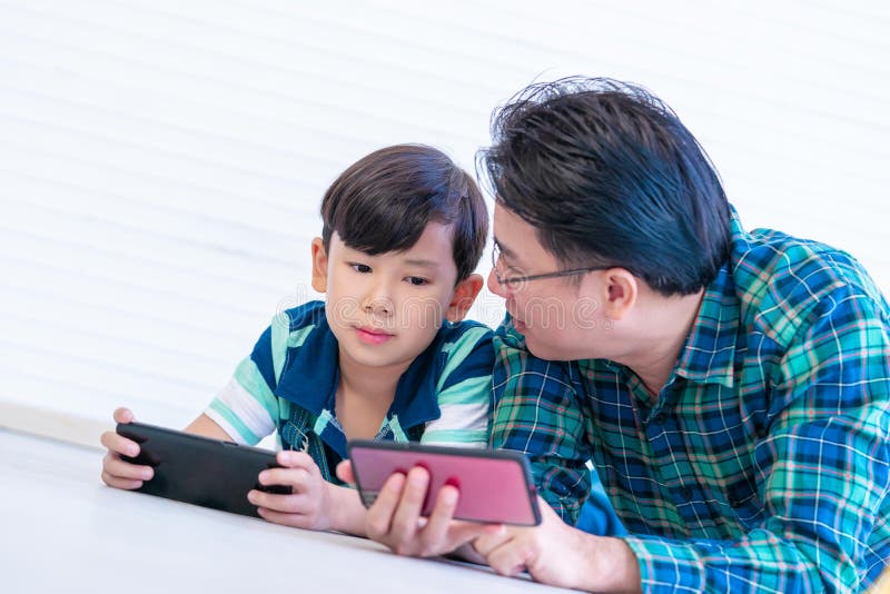 Father and Son in Using Smartphone Together for Modern Family and ...